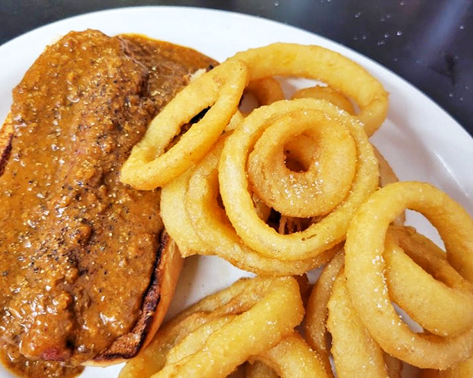 Crispy on the outside, tender within&mdash;these onion rings and sandwich combo represent the platonic ideal of diner indulgence. Diet plans come here to die gloriously.