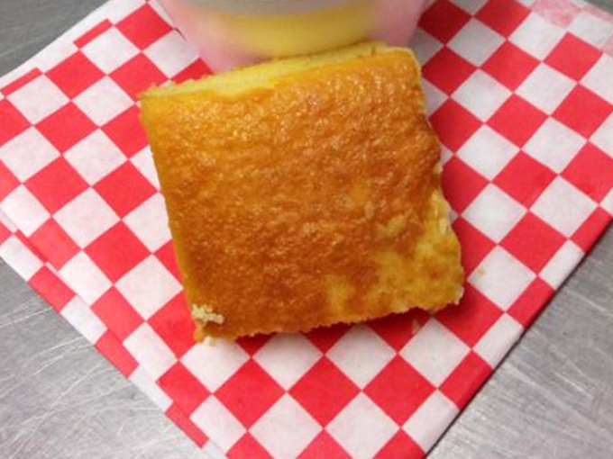 Cornbread so golden it belongs in Fort Knox, served on the classic red-checkered paper that's practically BBQ's official flag.