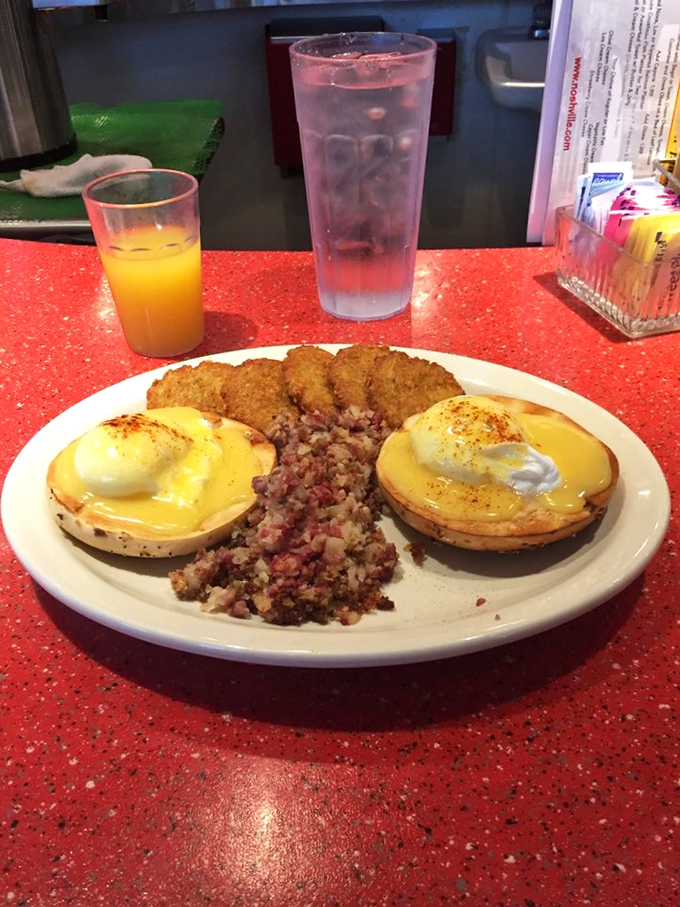 Eggs Benedict with a side of corned beef hash&mdash;proof that breakfast can be both elegant and hearty simultaneously. The hollandaise speaks volumes.