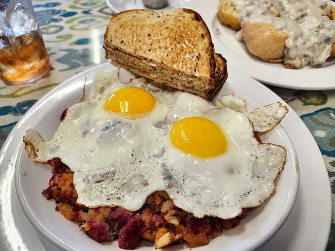 Corned beef hash that means business, crowned with sunny-side-up eggs that look like they're winking at you with delicious promises.