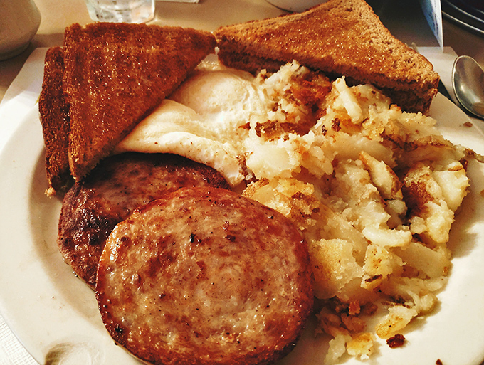 The holy trinity of breakfast: perfectly cooked eggs, golden toast, and corned beef hash that makes you question all other breakfast decisions you've ever made.
