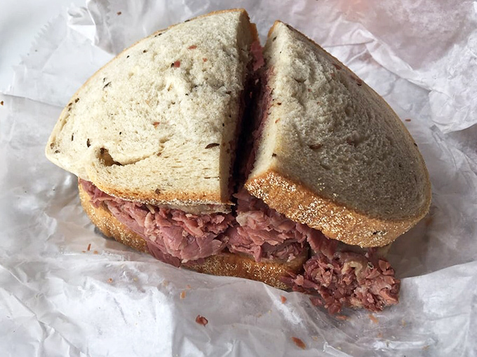 Corned beef so tender it practically surrenders at first bite, nestled between bread that's achieved that golden-brown perfection we all dream about.