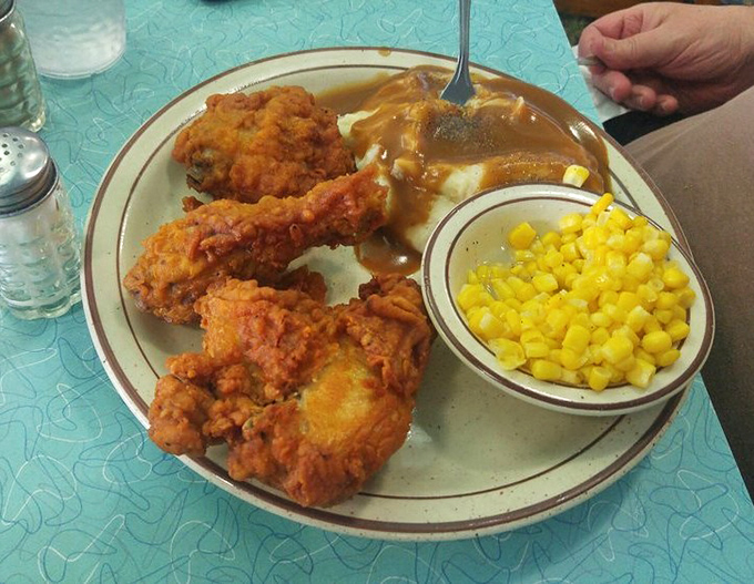 Comfort food masterpiece alert! Golden fried chicken alongside mashed potatoes drowning in gravy &ndash; your diet's worst nightmare and your soul's best friend.