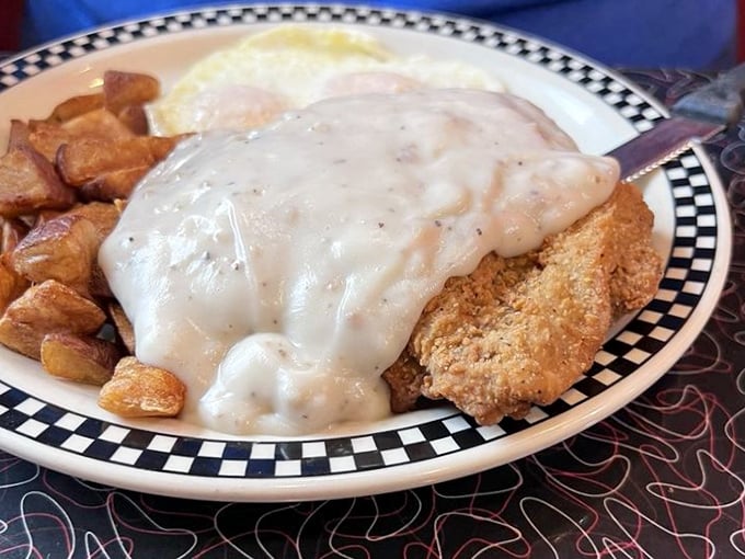 Country fried steak with gravy so generous it's practically a weighted blanket for your breakfast. Comfort food architecture at its finest.