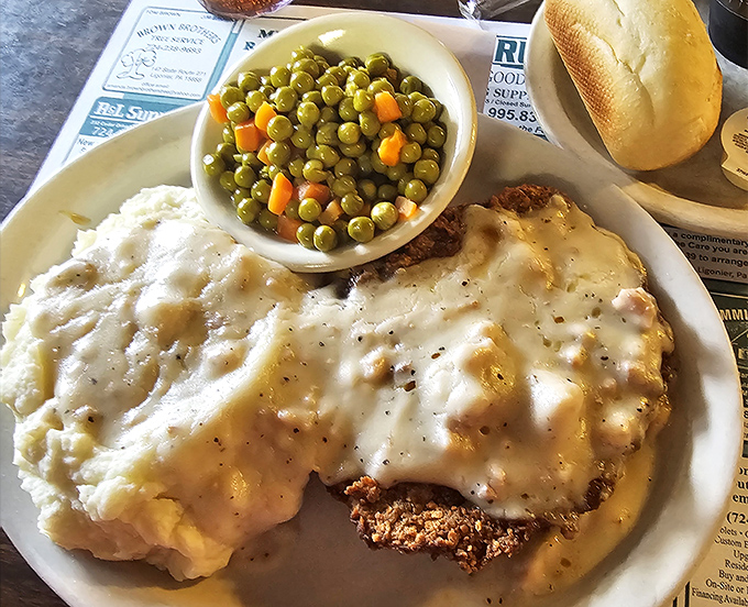 Country fried steak with a lake of creamy gravy that would make your cardiologist wince and your soul sing. Worth every delicious calorie.