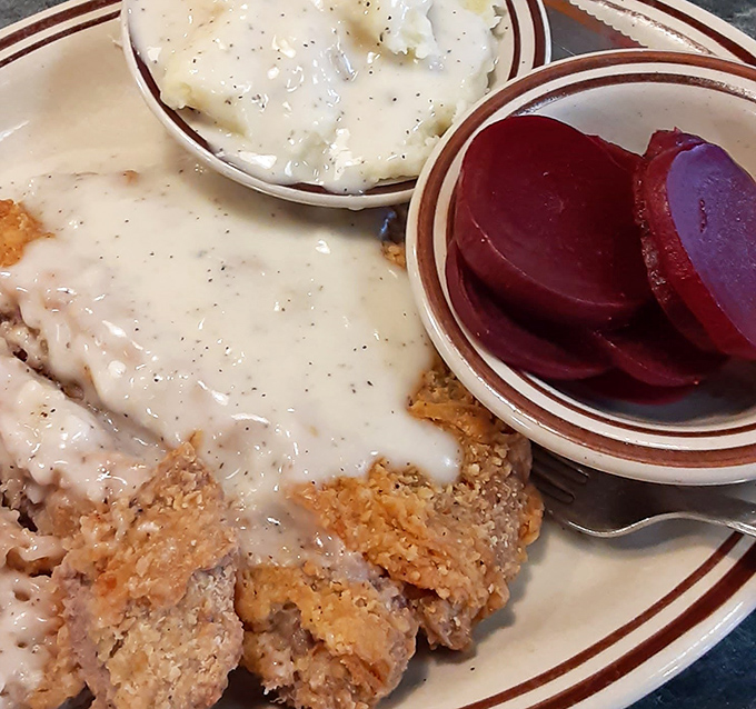 Country fried steak swimming in creamy gravy with pickled beets on the side&mdash;comfort food that hugs your insides like a warm Pennsylvania blanket.