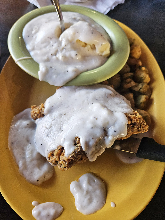 Country fried steak smothered in that legendary gravy alongside a biscuit that could make a grown person cry. This is Southern comfort defined.