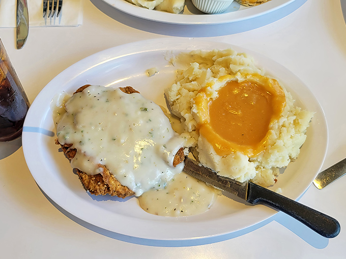 Country fried steak swimming in gravy &ndash; because sometimes your arteries deserve a vacation too.