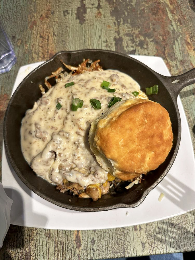 Cast iron skillet presentation means business: this Country Style loaded with sausage gravy proves Southern breakfast doesn't do subtlety.