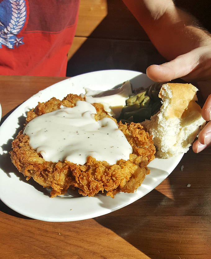 Country fried steak smothered in gravy that could make a vegetarian weep with temptation. That biscuit isn't just a side&mdash;it's an essential gravy delivery system.