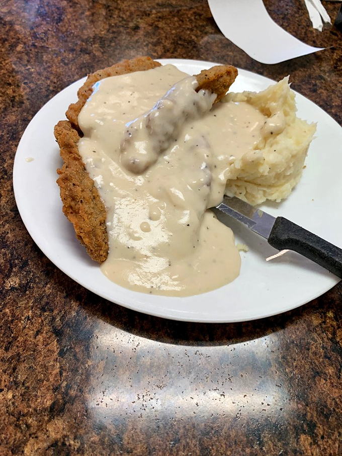 This country fried steak doesn't just come with gravy&mdash;it swims in it gloriously, with mashed potatoes standing by as willing accomplices to deliciousness.