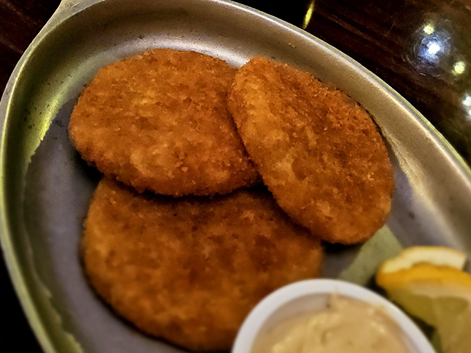 Golden-brown crab cakes with a side of zesty sauce&mdash;because sometimes even dedicated carnivores need a brief seafood intermission.