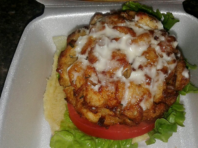 Not just any crab cake—a masterpiece of lump meat barely held together by hope and a prayer, crowned with creamy sauce.