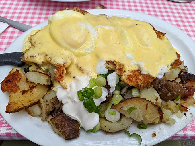 The Benedict that launched a thousand road trips. Golden hollandaise cascades over crab cakes in this morning masterpiece.