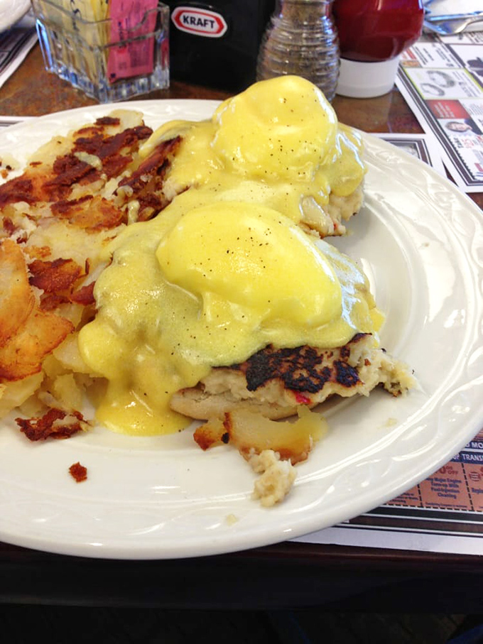 Eggs Benedict done right: perfectly poached eggs draped in hollandaise that flows like liquid gold, alongside crispy home fries that'll make you forget all your breakfast loyalties.