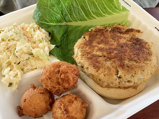 This isn't just a crab cake—it's edible evidence that simplicity triumphs over pretension. Golden-brown perfection with hush puppies standing guard.