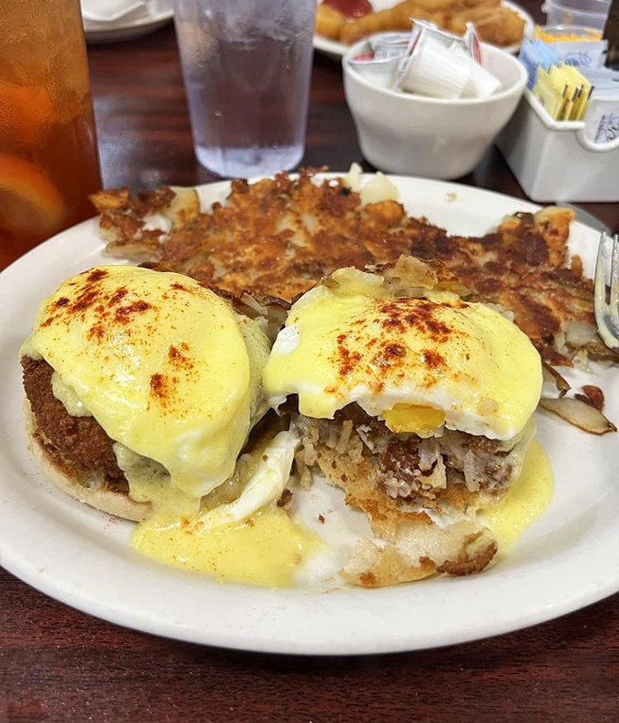 Behold the Eggs Benedict in its natural habitat – poached eggs wearing hollandaise like a velvet robe over what appears to be crab cakes.