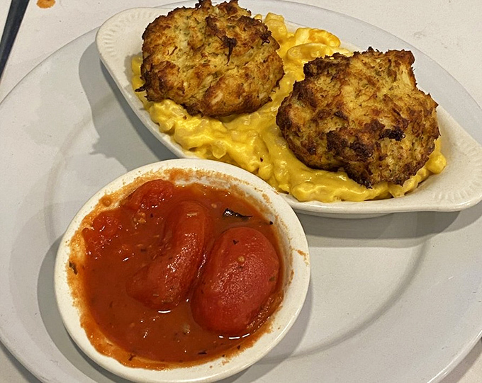 These aren't just crab cakes&mdash;they're golden-crusted Delaware treasures sitting atop a bed of mac and cheese that would make your grandmother jealous.