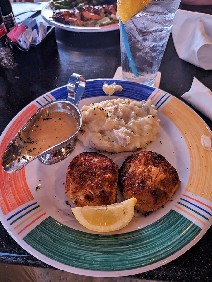 These crab cakes aren't just browned&mdash;they're bronzed, like Florida retirees who've found their perfect beach spot. The sauce boat is a welcome companion.