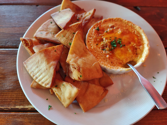 Crispy pita triangles standing at attention, ready for their mission: delivering creamy, cheesy crab dip to your eagerly waiting taste buds.