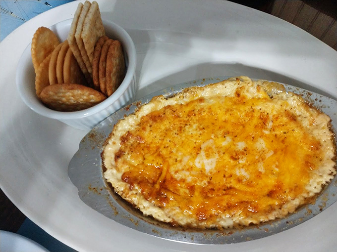 The crab dip arrives bubbling hot, a molten treasure chest of cheese and crab meat that makes those accompanying crackers the luckiest dippers in Maryland.
