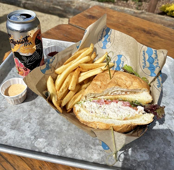 This isn't just a sandwich; it's a love letter to the Pacific, with fresh crab nestled between crusty bread alongside perfectly golden fries and local craft beer.