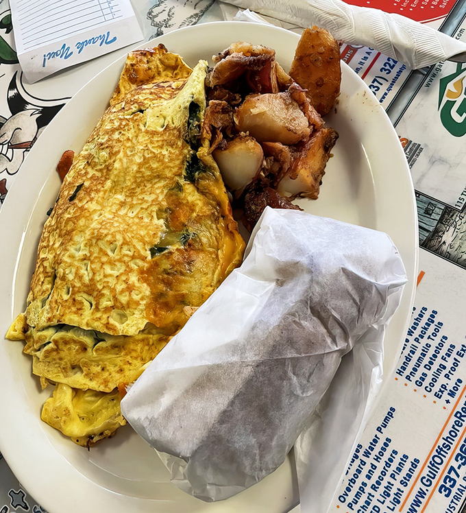 That omelet's packed tighter than a Mardi Gras parade route, with crawfish peeking out like delicious surprises.