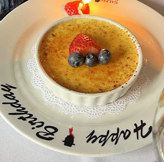 Cr&egrave;me br&ucirc;l&eacute;e with the perfect crack-worthy crust says "Happy Birthday" in the universal language of caramelized sugar. Those berries? Just showing off.
