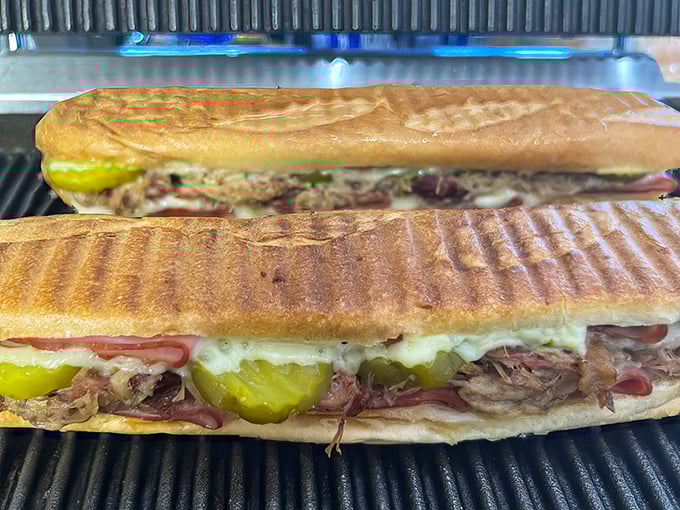 The pressed Cuban sandwich reveals its glorious cross-section. Like a geological formation of deliciousness, each layer tells a delicious story.