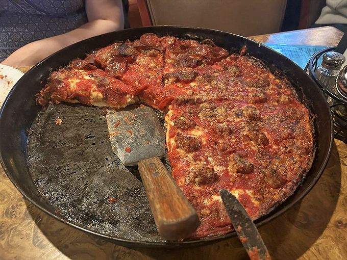 The pizza arrives like a savory work of art&mdash;caramelized crust, bubbling cheese, and that signature sauce on top. Architecture you can eat.