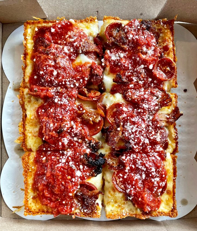 Detroit-style pizza in all its glory &ndash; those crispy, caramelized cheese edges are the culinary equivalent of finding an extra $20 in your pocket.