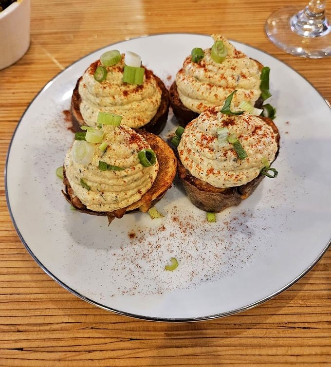 These deviled potato skins with their perfect piping and paprika dusting aren't just appetizers &ndash; they're edible art that happens to taste incredible.