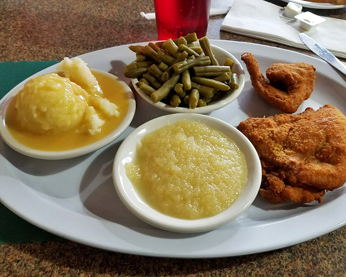 The holy trinity of Barberton chicken dining: crispy fried chicken, creamy mashed potatoes, and green beans that have found their purpose in life as the perfect sidekick.