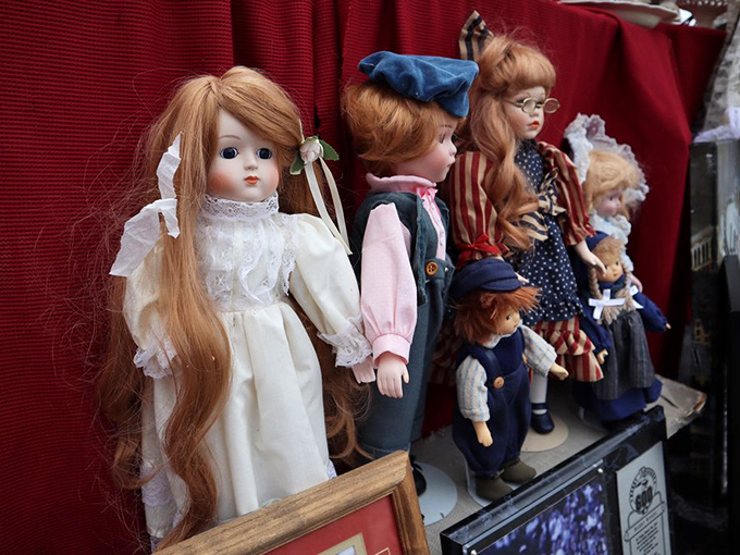 The doll committee is now in session. These porcelain-faced time travelers have seen decades come and go, their expressions eternally patient.