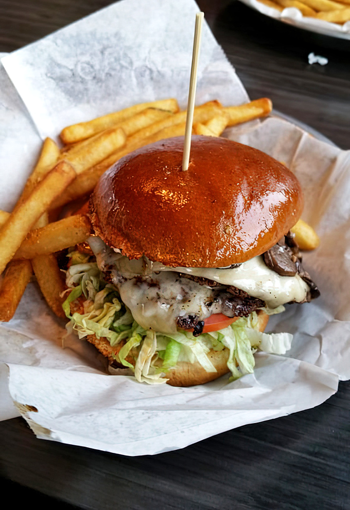 The Drunken Mushroom burger isn't just food—it's architecture, engineering, and art all stacked between a glossy brioche bun.