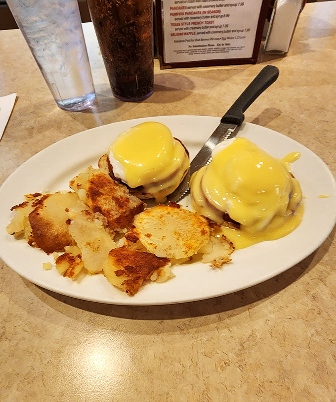 Eggs Benedict that would make a brunch enthusiast weep tears of hollandaise joy, paired with home fries that achieve the perfect crisp-to-tender ratio.