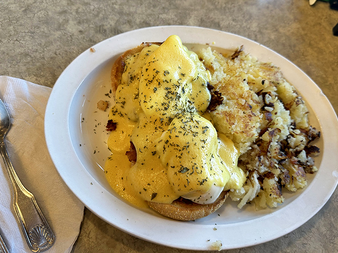 Eggs Benedict done right&mdash;a perfect hollandaise cascade over poached eggs with hash browns that achieve that magical crispy-outside, tender-inside perfection.