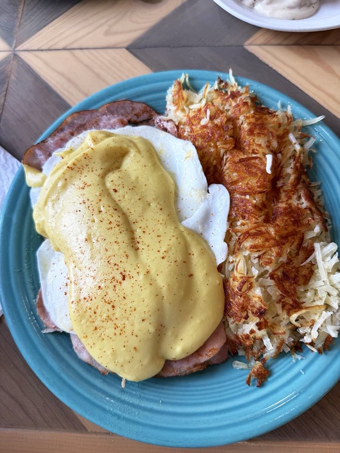 Hollandaise sauce should be its own food group. Here it blankets eggs and ham like a golden comforter, with those crispy hash browns standing guard.