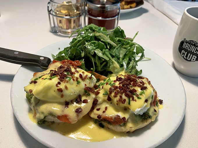 Benedict done right &ndash; perfectly poached eggs cascade over English muffins like lava from a delicious volcano, with bacon bits for extra joy.