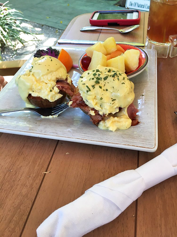 Eggs Benedict done right: a hollandaise waterfall cascading over perfectly poached eggs with a side of fresh fruit that actually tastes fresh.