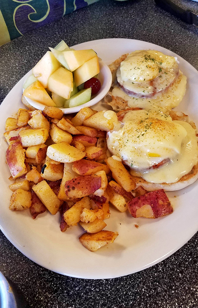Eggs Benedict with home fries that look like they've been personally introduced to butter and seasonings that actually have flavor.