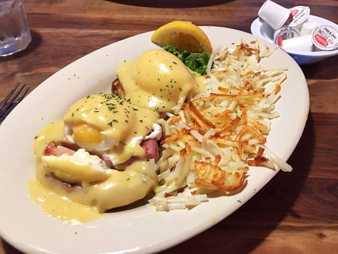 Eggs Benedict gets the coastal treatment with what appears to be seafood hiding under that golden hollandaise blanket &ndash; breakfast of champions indeed.