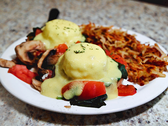 These Eggs Benedict aren't just breakfast, they're an event &ndash; poached eggs wearing hollandaise jackets atop a bed of vegetables and crispy hashbrowns.