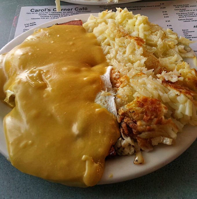 Country gravy cascading over crispy chicken fried steak like a savory waterfall, with hash browns standing by for backup duty. A breakfast of champions.