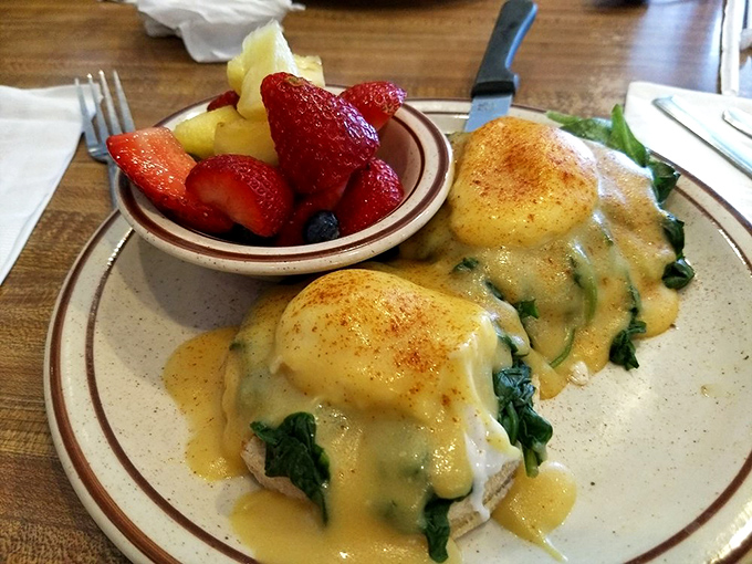 Eggs Florentine that would make Popeye weep with joy, accompanied by fresh fruit that doesn't feel like a consolation prize.