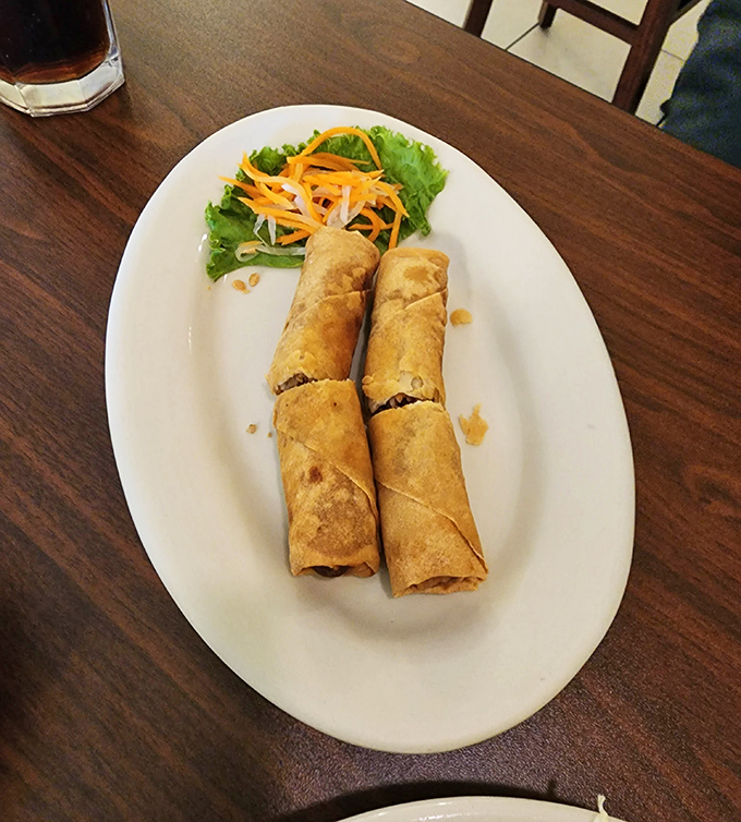 Spring rolls that crunch with freshness. These golden cylinders are like edible time machines to Saigon street markets.
