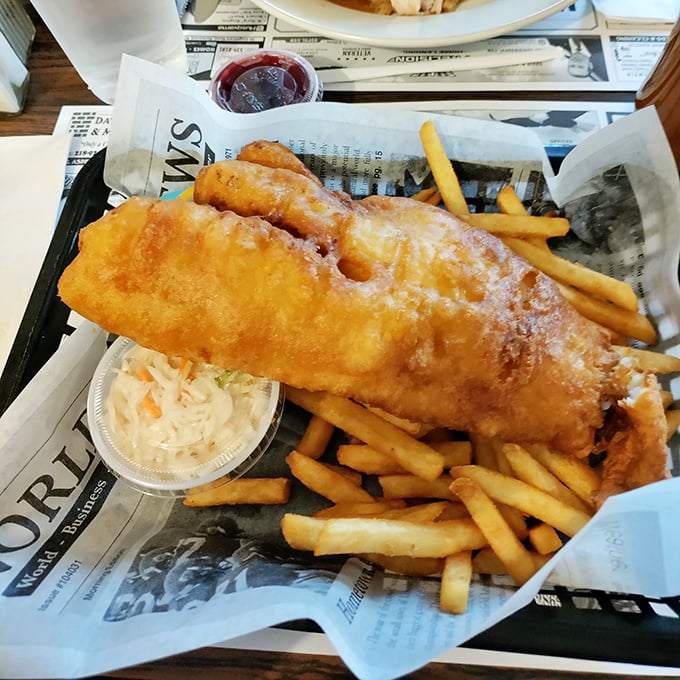 Fish and chips served on newspaper – a nod to tradition that tastes as good as it looks. That golden batter is singing a siren song.