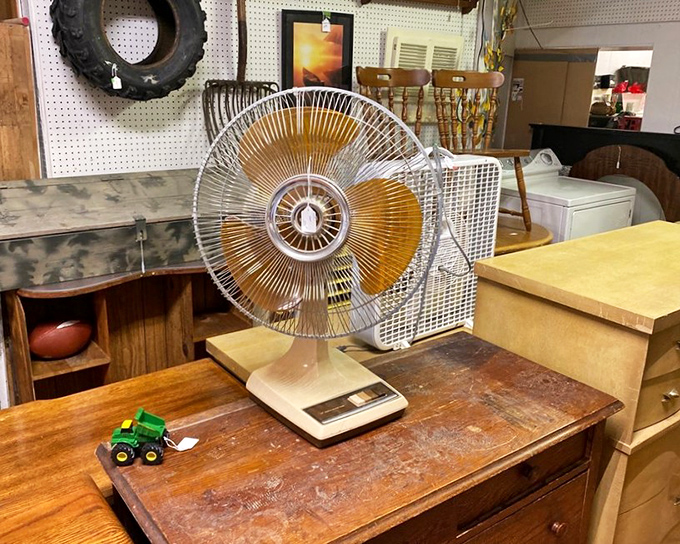 This vintage oscillating fan isn't just cooling a room anymore &ndash; it's blowing memories of summers past right next to a tiny John Deere tractor.