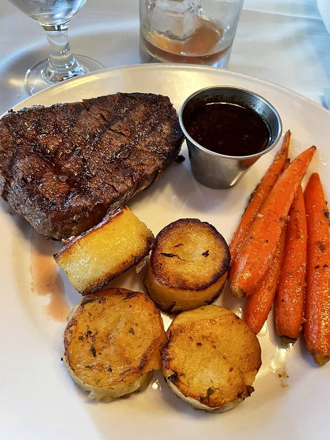 A perfectly seared filet mignon shares the spotlight with roasted potatoes and carrots &ndash; proof that simplicity, when done right, is culinary genius.
