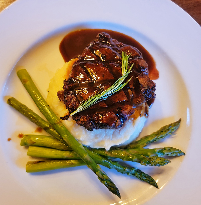 Filet mignon that's dressed for success. Perched atop creamy mashed potatoes with a rich sauce that deserves its own fan club.
